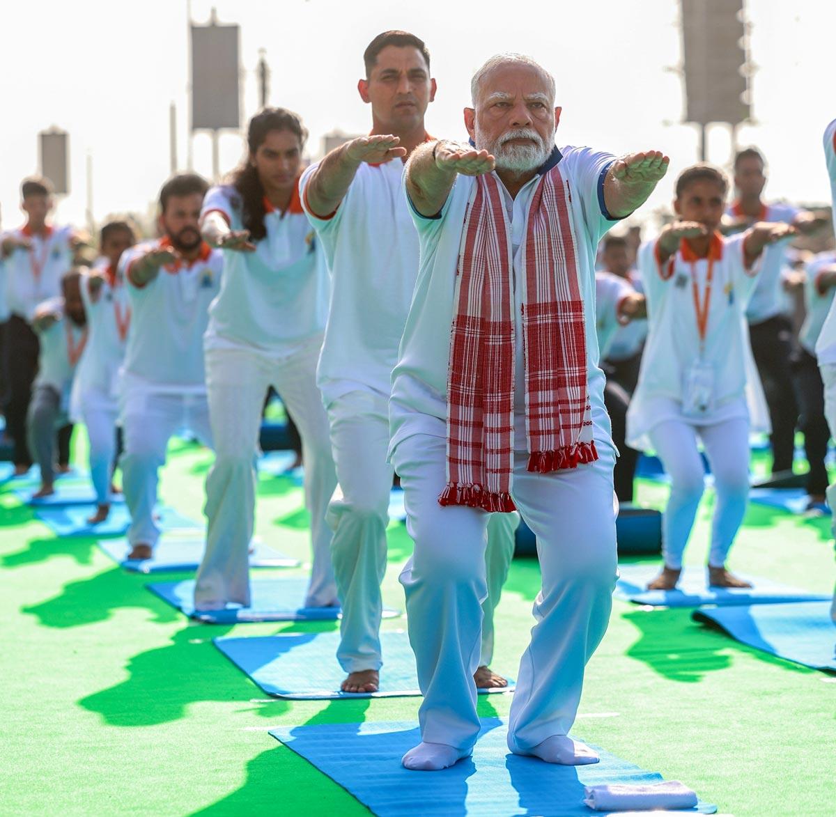 Twist and bend: Modi performs yoga from Vizag beach - Rediff.com India News