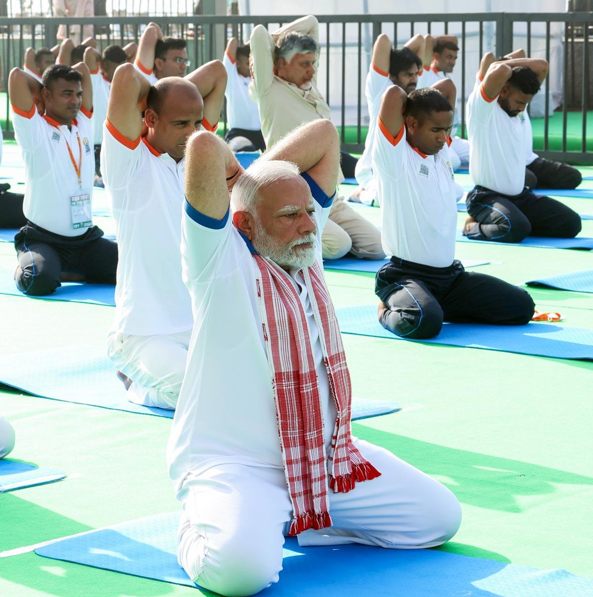 Twist and bend: Modi performs yoga from Vizag beach - Rediff.com India News